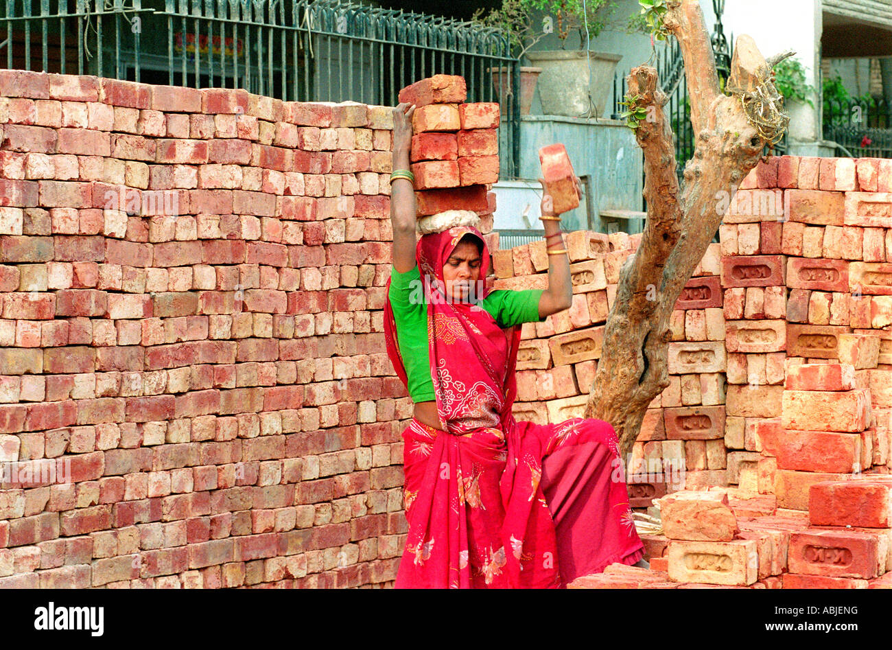 Woman carrying bricks hi-res stock photography and images - Alamy