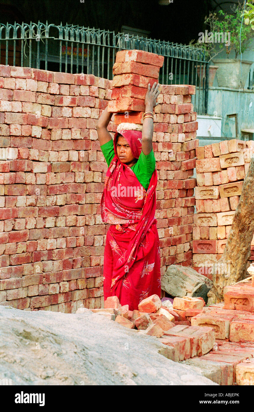 Woman carrying bricks hi-res stock photography and images - Alamy