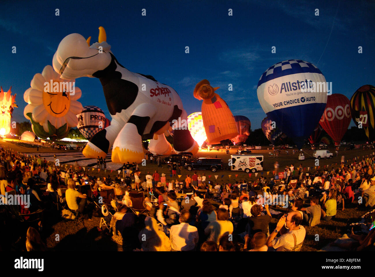 Air balloons rising at night in a meadow for a festival Stock Photo - Alamy