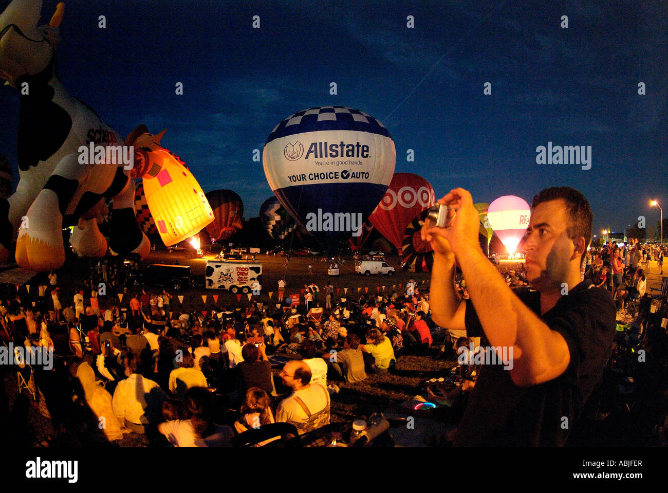 Air balloons rising at night in a meadow for a festival Stock Photo - Alamy