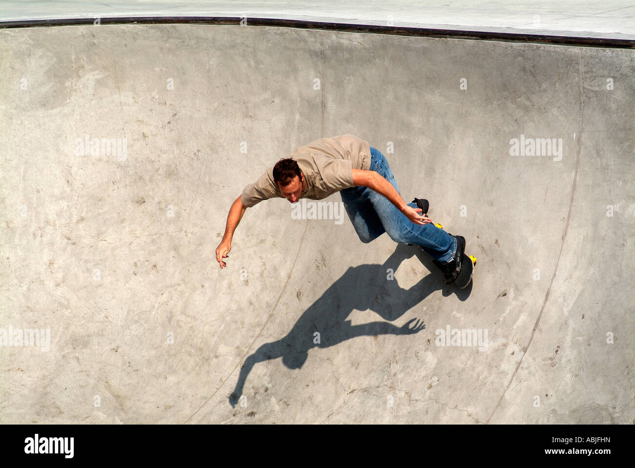 Young man skating in a park on a concrete ramp Stock Photo - Alamy
