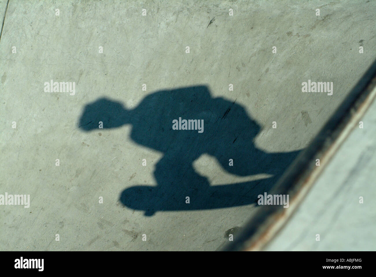 Shadow of a young teenager skating in a park on a concrete ramp Stock ...