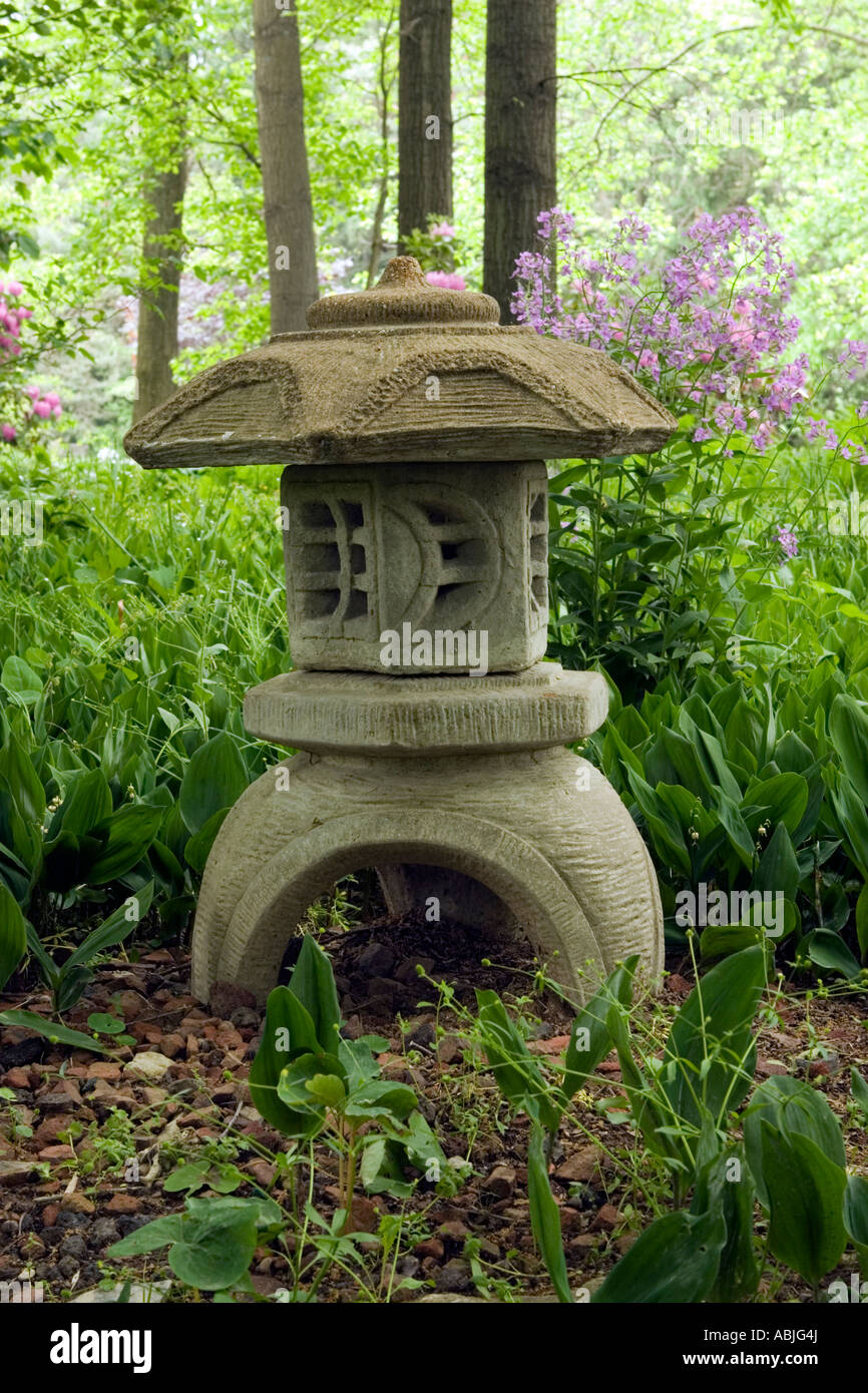 Asian stone sculpture in a city park garden Stock Photo - Alamy