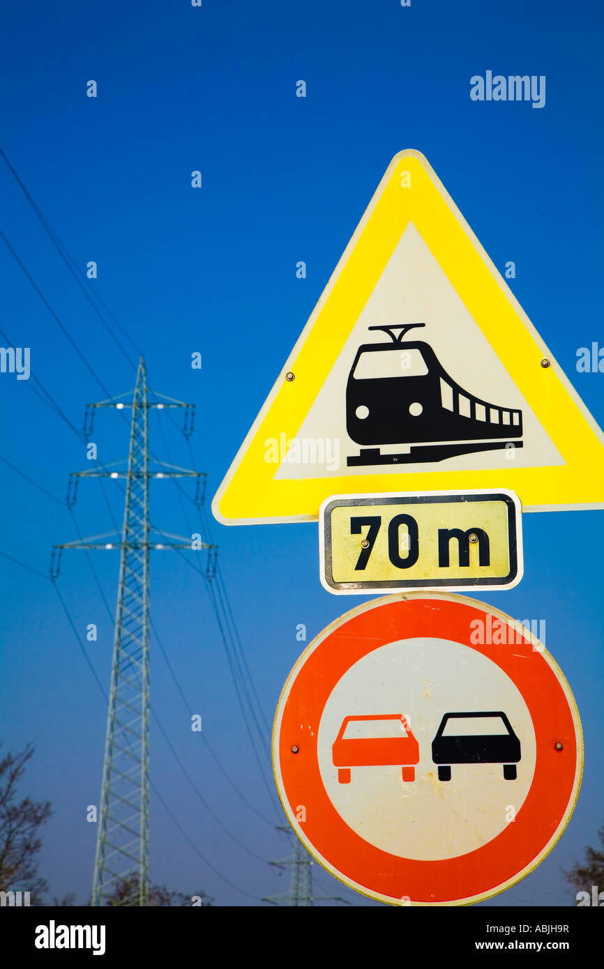 Electric pylon and train crossing Stock Photo - Alamy