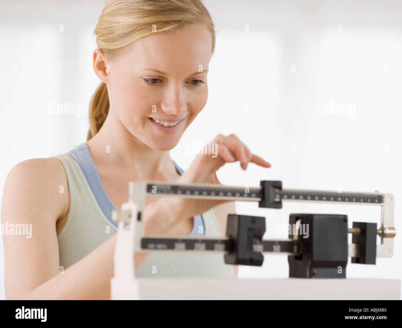 Woman weighing self on scale Stock Photo - Alamy Woman weighing self on scale Stock Photo - Alamy