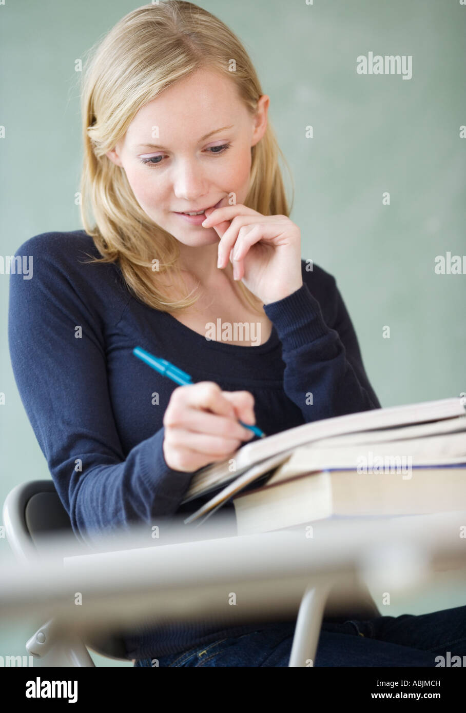 Woman writing in notebook Stock Photo - Alamy