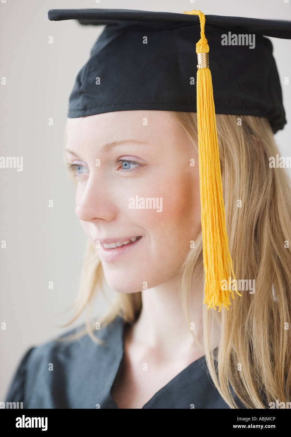 Woman wearing graduation cap and gown Stock Photo - Alamy