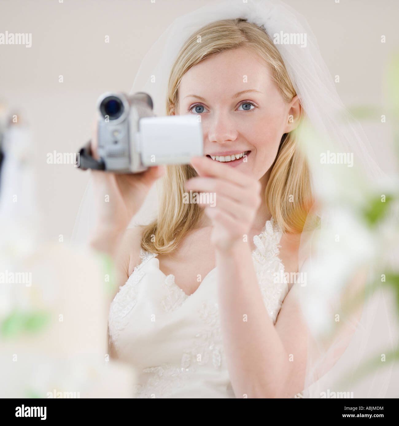 Bride using video camera Stock Photo - Alamy