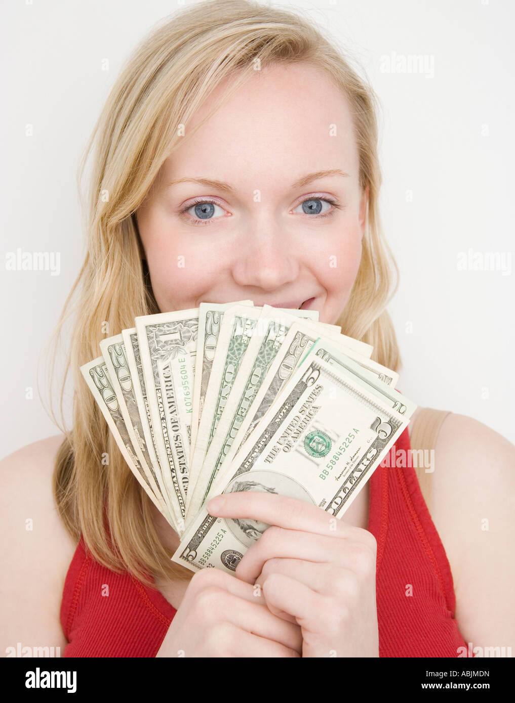 Woman holding fanned out money Stock Photo - Alamy
