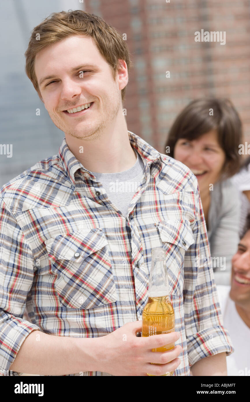 Man holding beer at party Stock Photo - Alamy