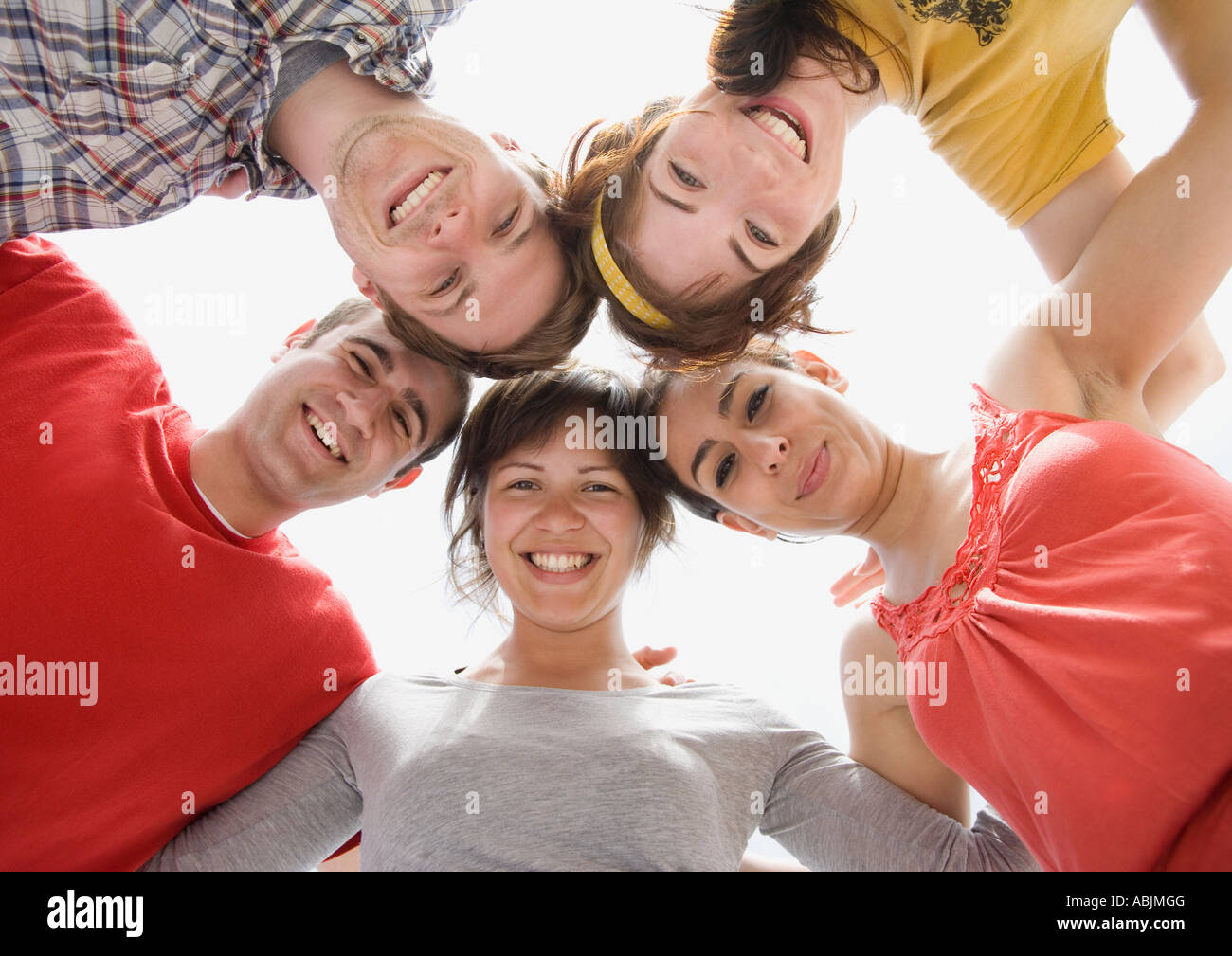 Friends in huddle Stock Photo - Alamy