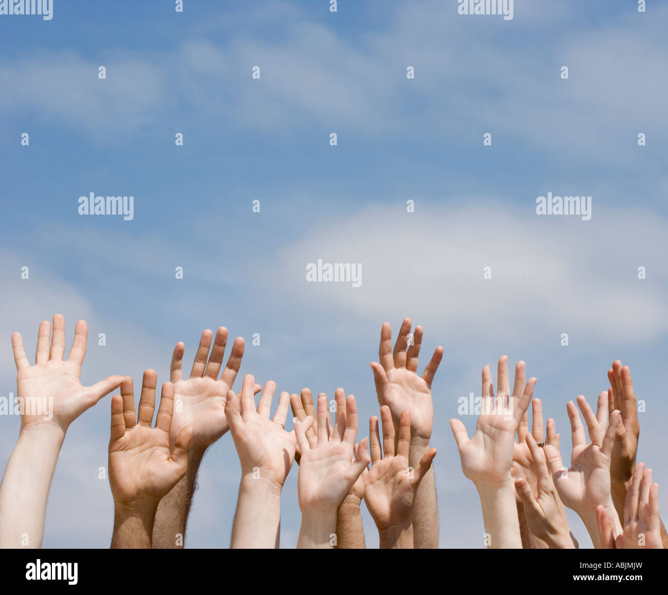 Hands raised under blue sky Stock Photo - Alamy