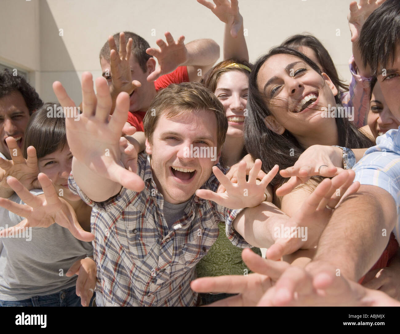 Friends reaching out hands and laughing Stock Photo - Alamy