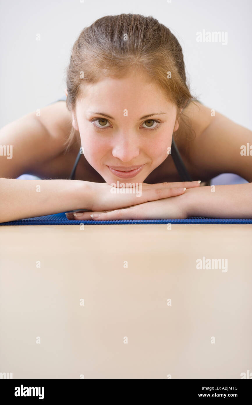 Woman laying on yoga mat Stock Photo - Alamy