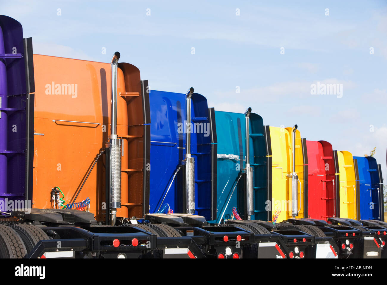 Rear view of row of tractor trailer cabs Stock Photo - Alamy