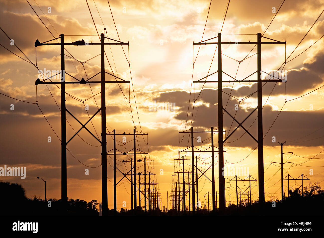 Electrical poles and wires at sunset Stock Photo - Alamy