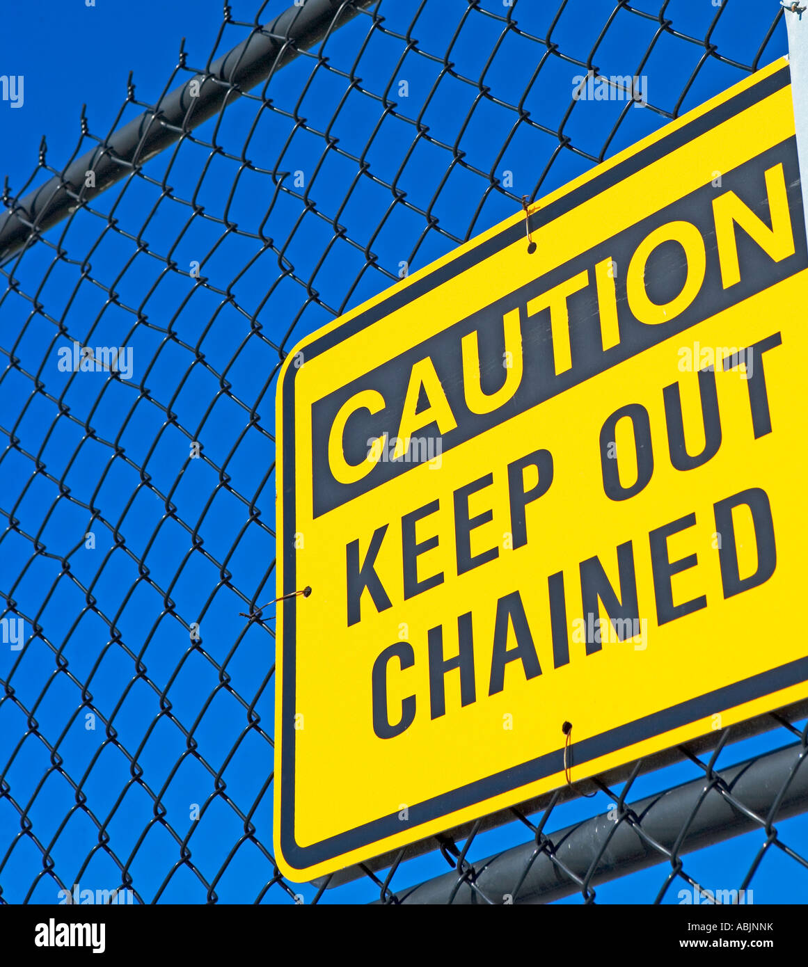 Caution Keep Out sign on fence Stock Photo - Alamy