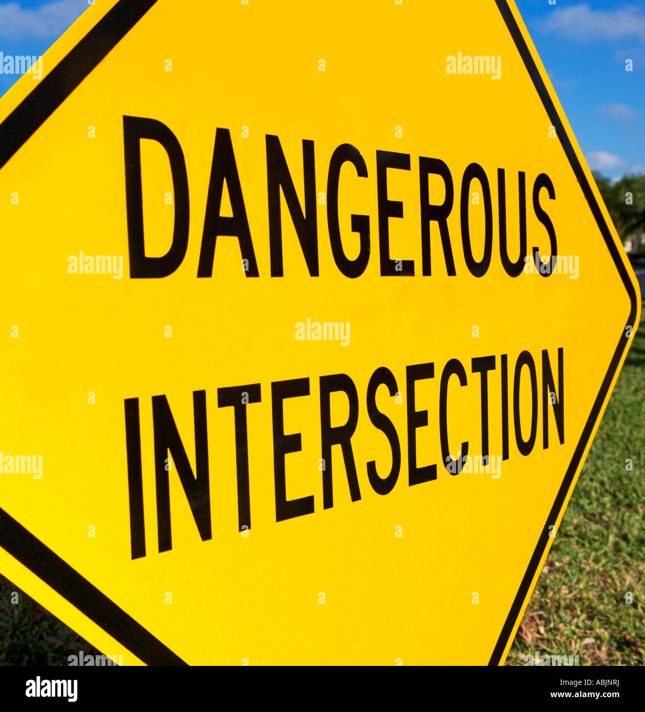 Close up of Dangerous Intersection sign Stock Photo - Alamy