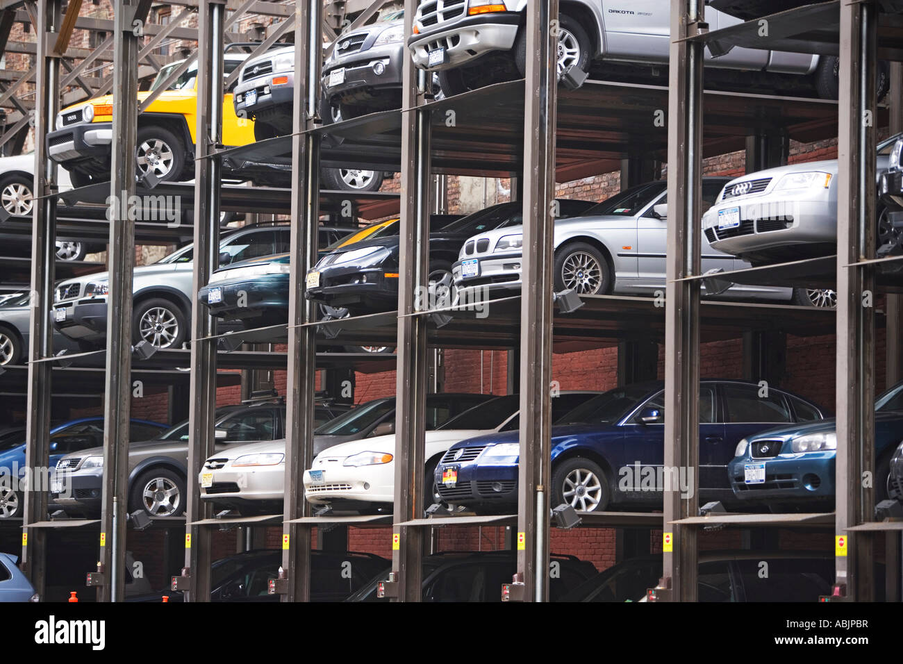 Cars stacked in urban parking lot Stock Photo - Alamy