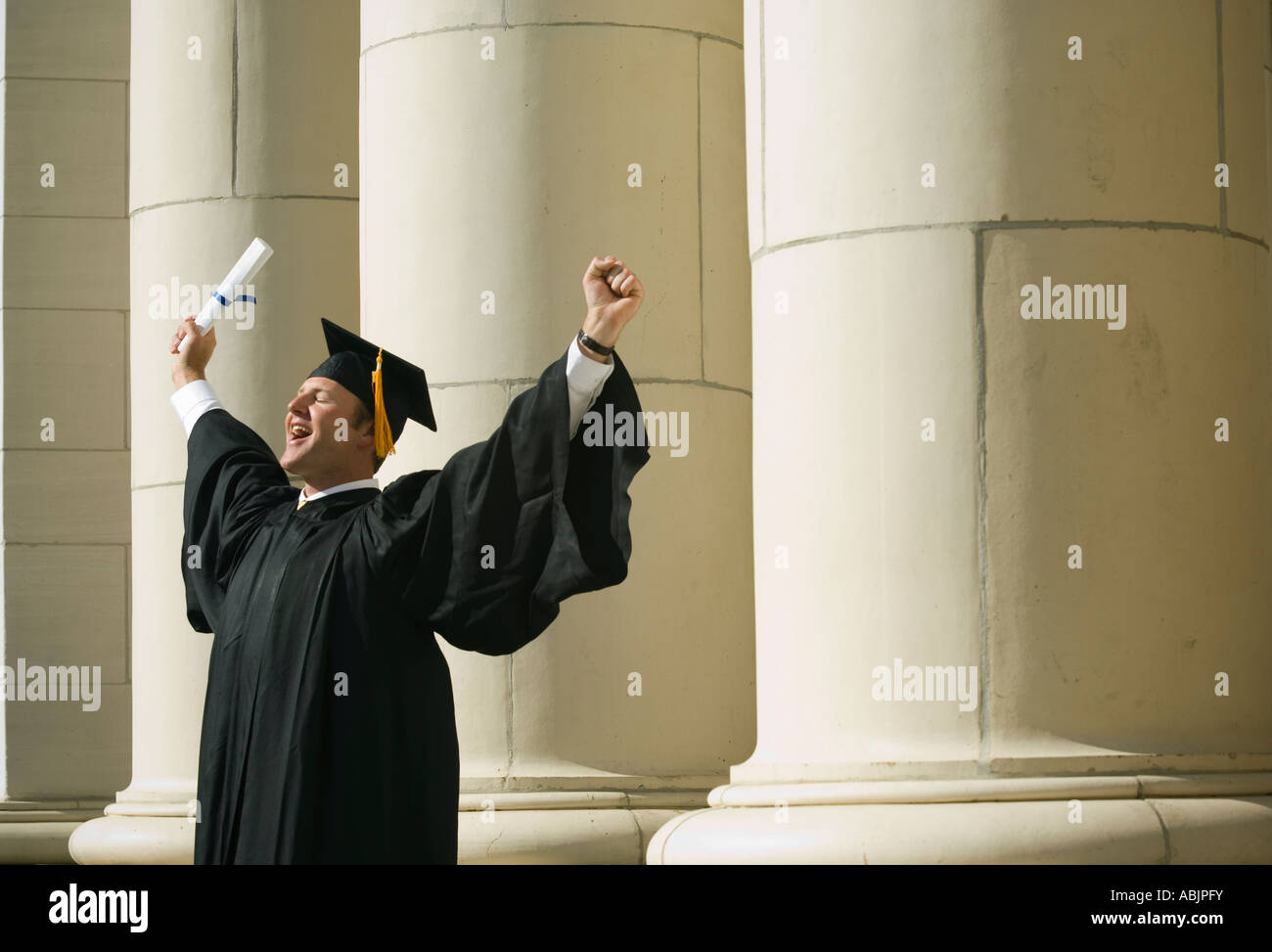 Male graduate cheering Stock Photo - Alamy