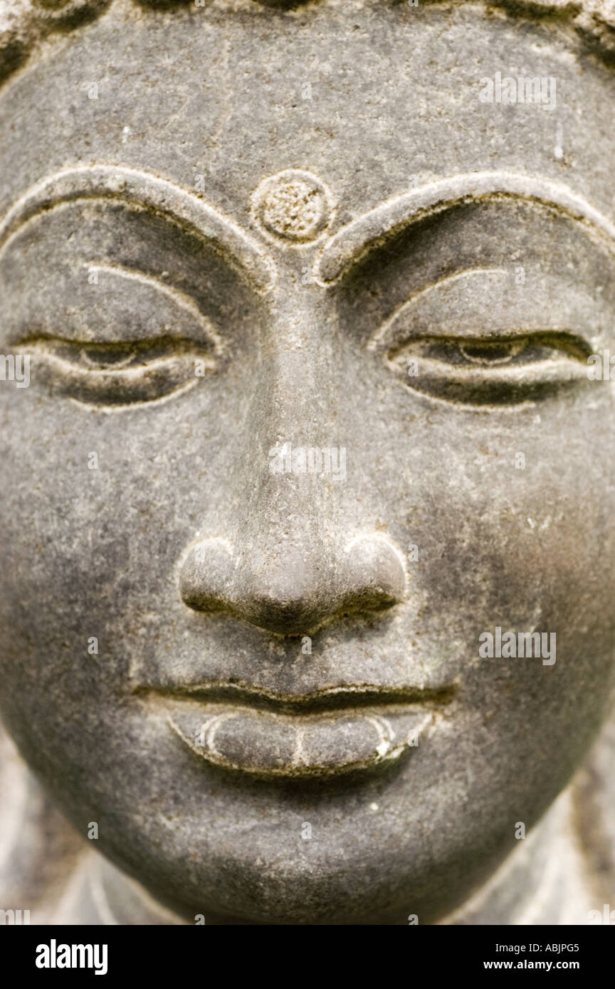 Face closeup of dtone statue of Lord Buddha meditating in Bodhgaya ...