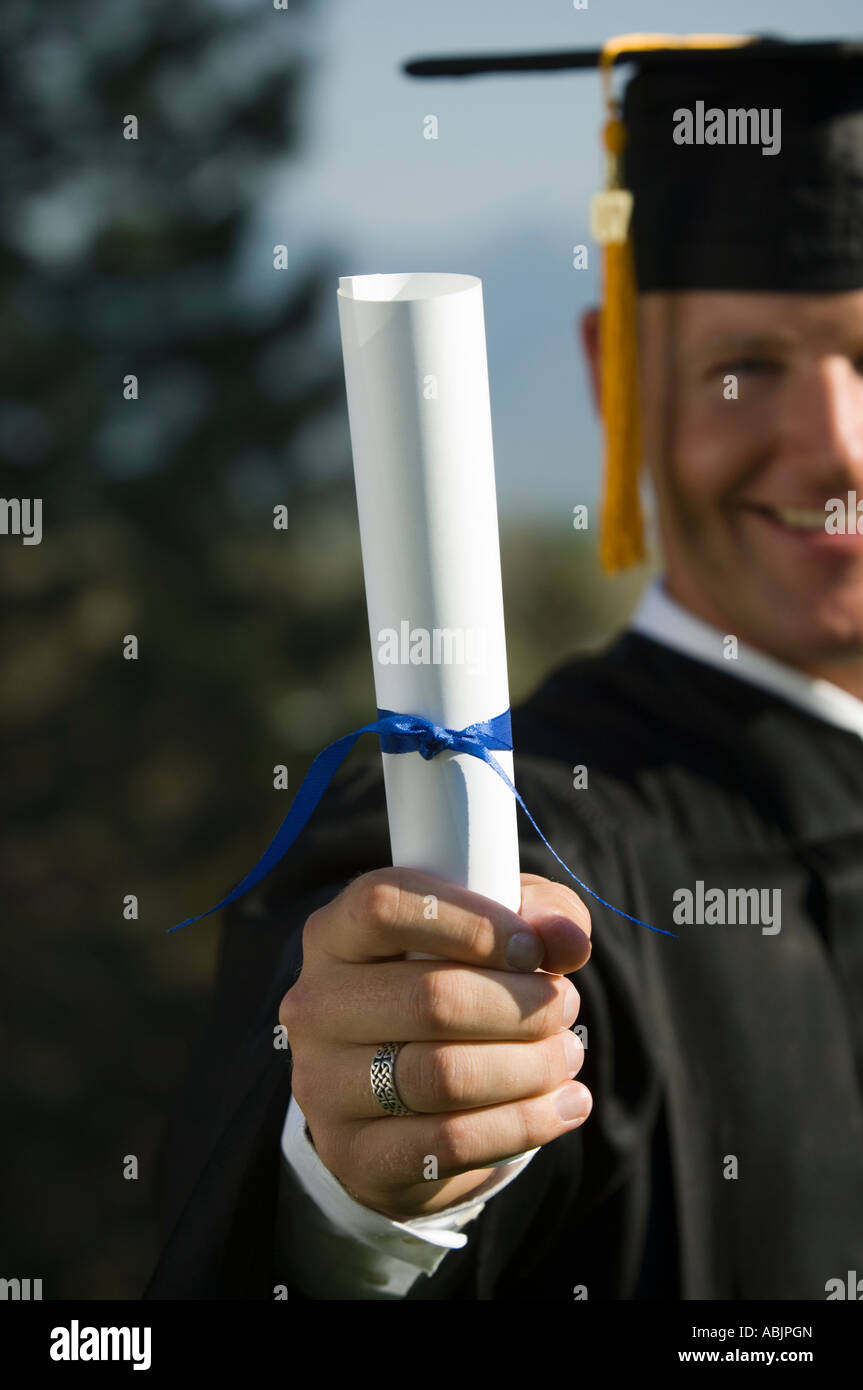 Male graduate holding diploma Stock Photo - Alamy