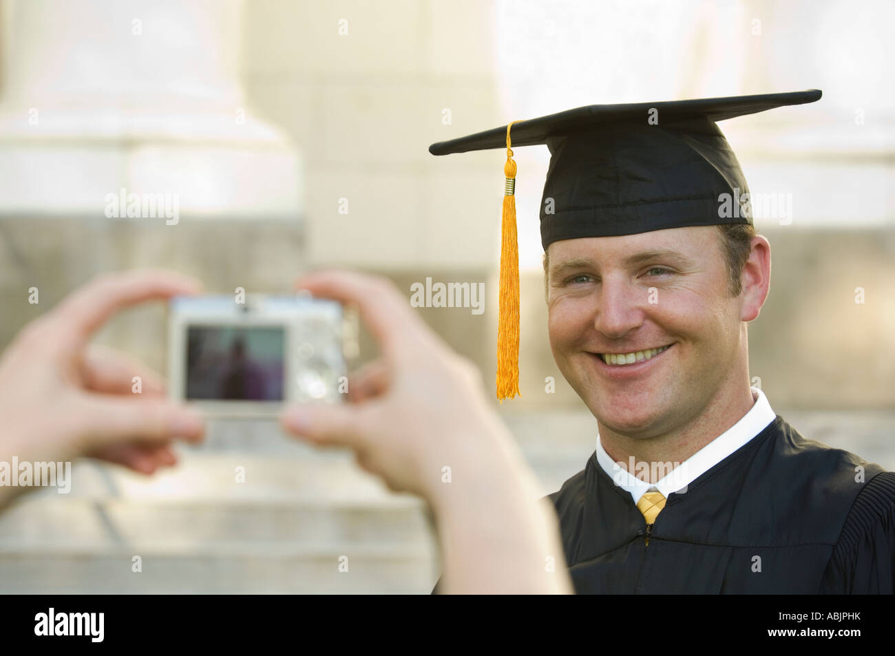 Male graduate having photograph taken Stock Photo - Alamy