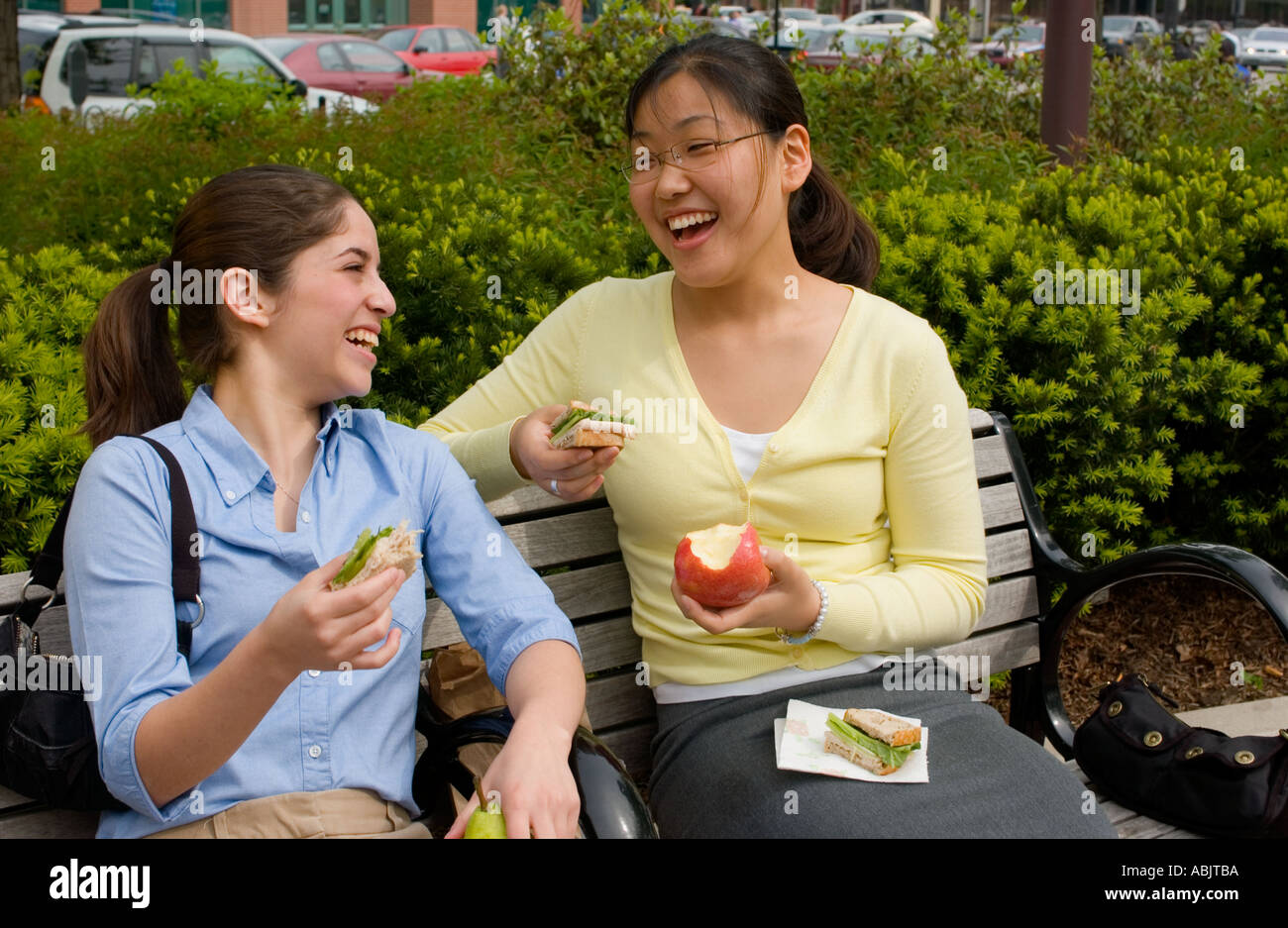 Hispanic American and Korean American girls eating healthy lunch ...