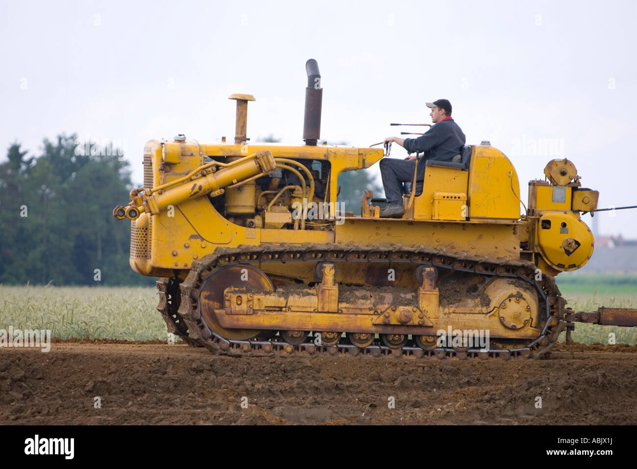 Caterpiller bulldozer towing agricultural machinery Stock Photo - Alamy