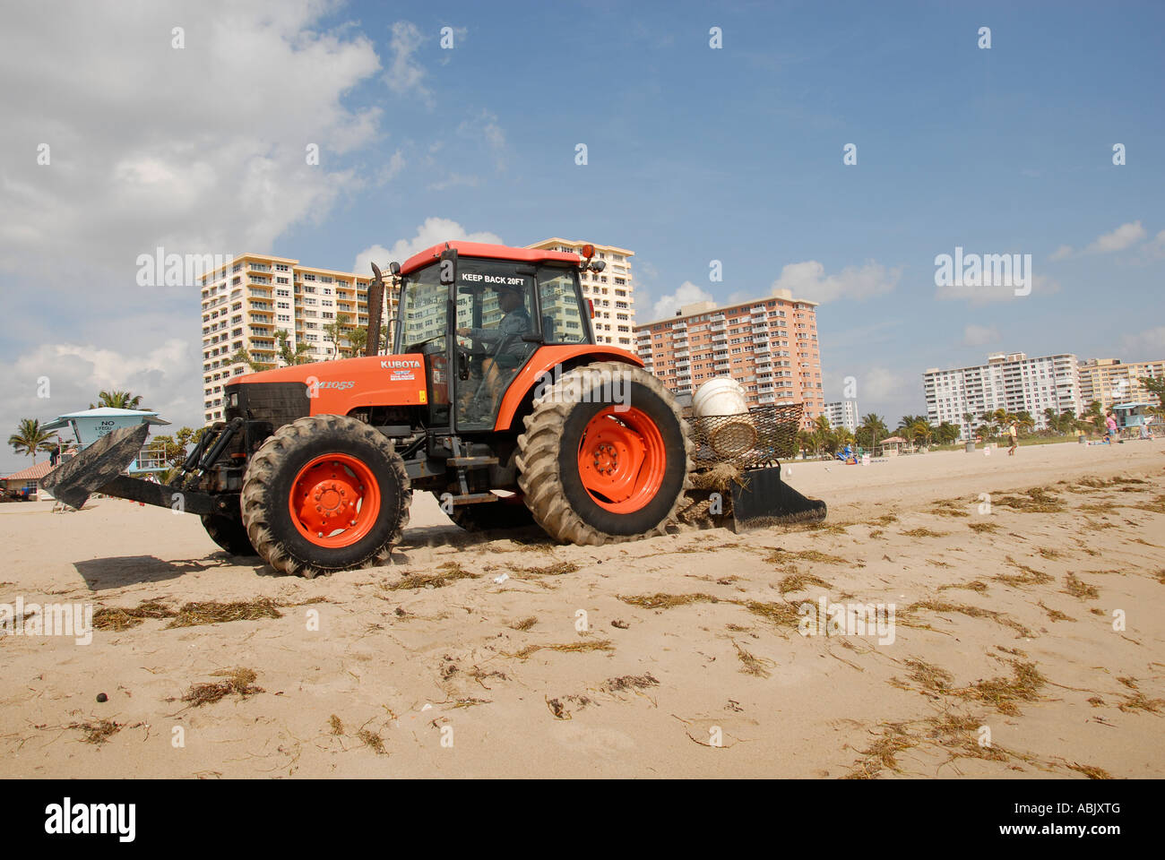 Tractor cleaning beach Stock Photo - Alamy