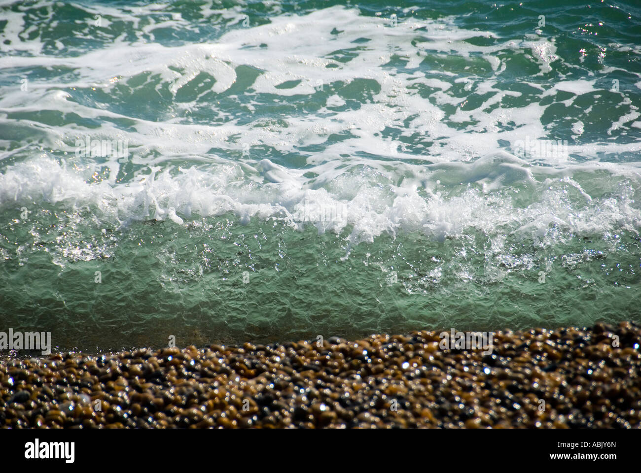 Backlit Wave Breaking Onto Chessil Beach Stock Photo - Alamy