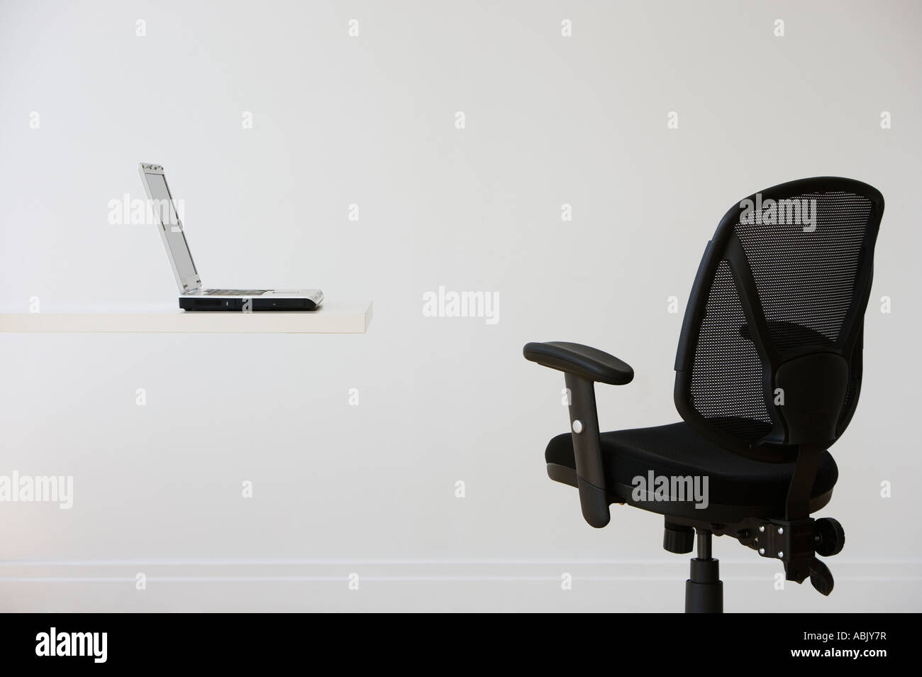 Empty desk with laptop Stock Photo - Alamy