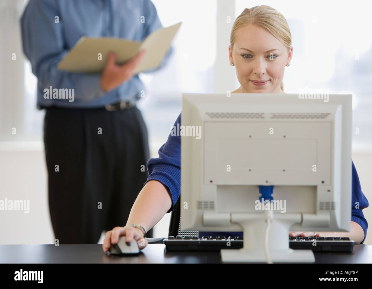 Businesswoman using computer at desk Stock Photo - Alamy