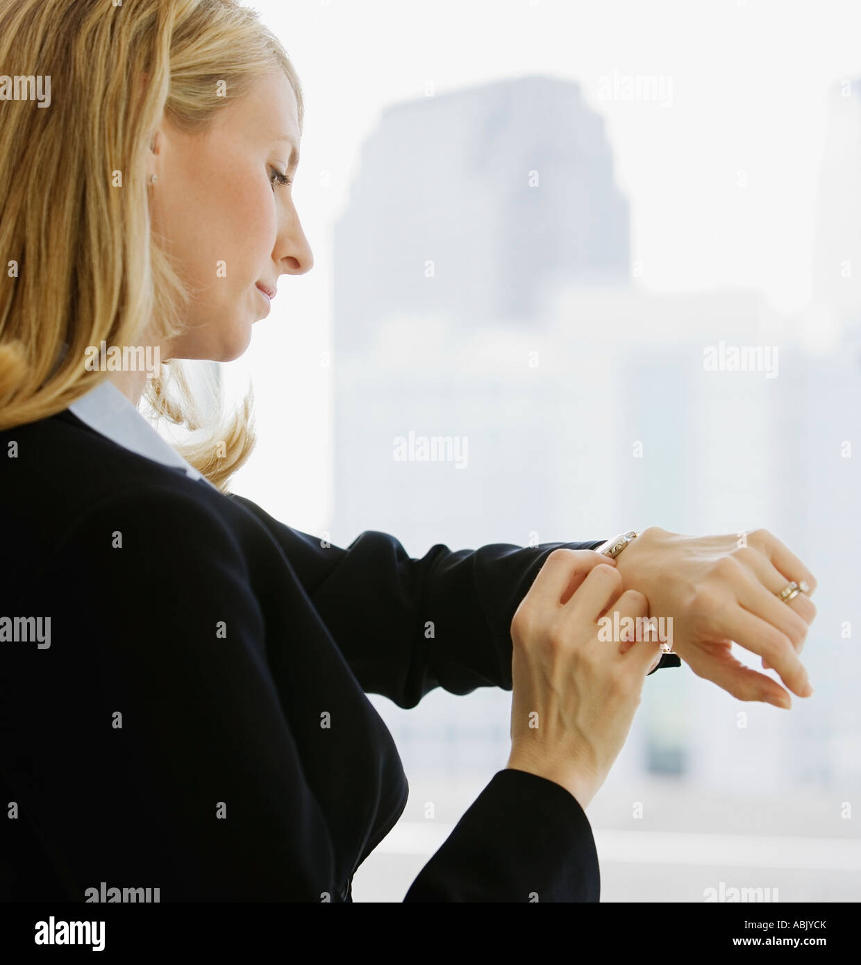 Businesswoman checking watch Stock Photo - Alamy