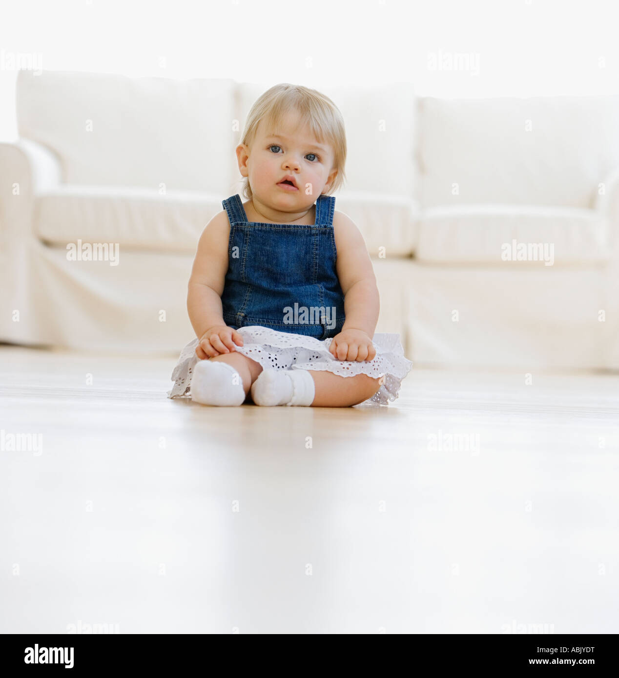 Baby sitting on floor Stock Photo - Alamy