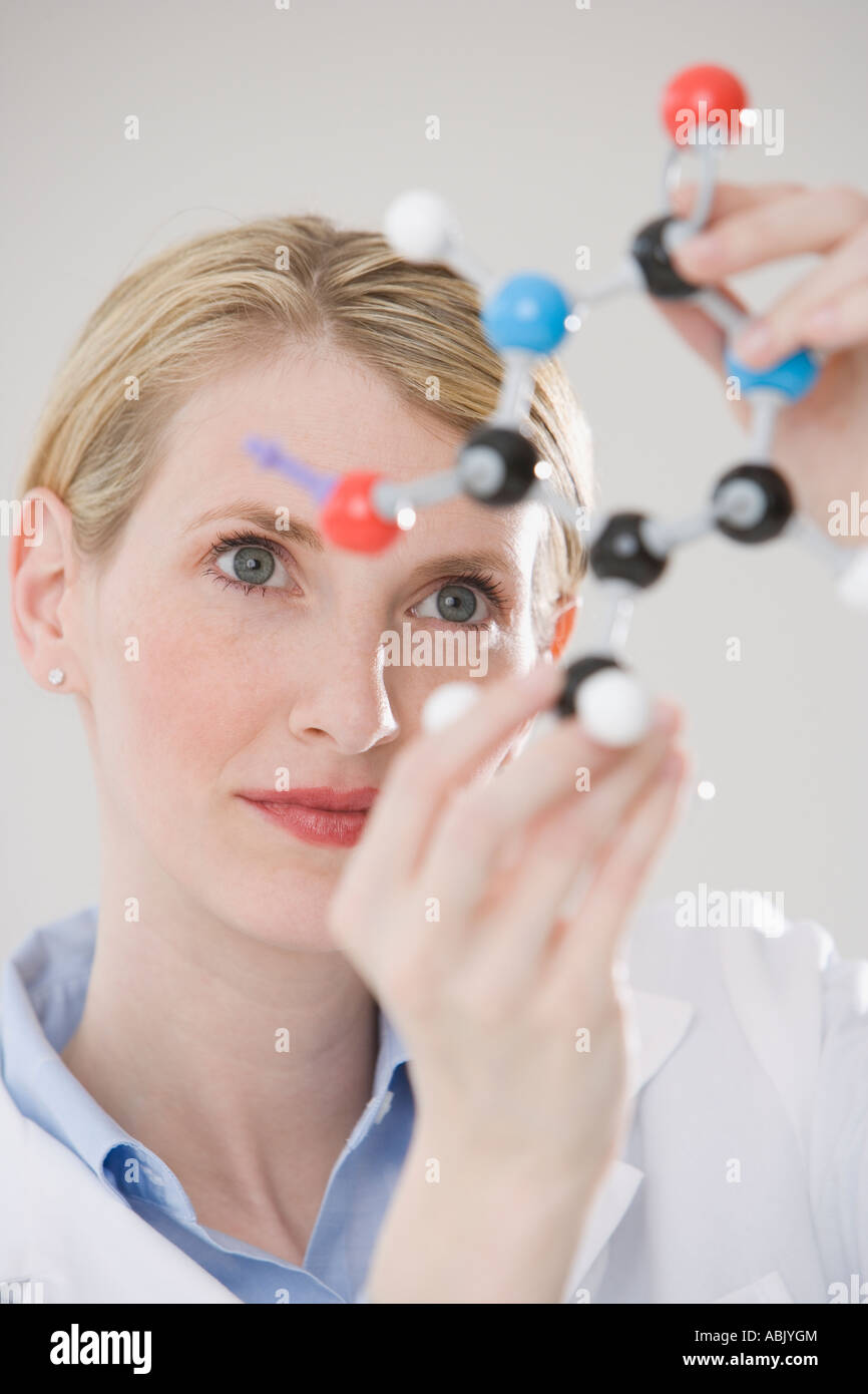 Female scientist looking at molecule model Stock Photo - Alamy