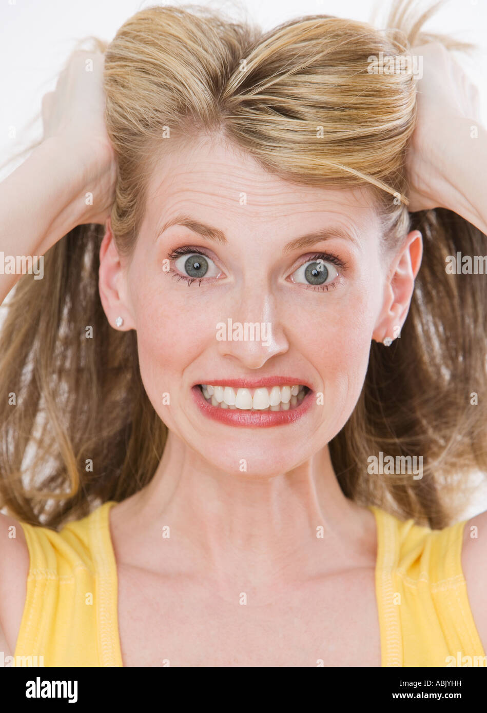 Frustrated woman pulling on hair Stock Photo - Alamy