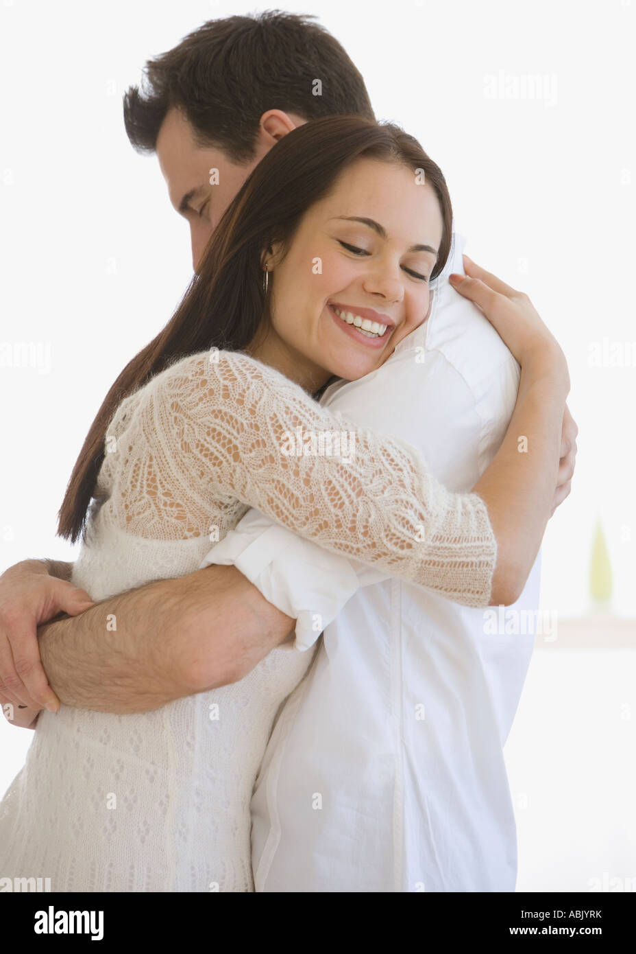 Couple hugging indoors Stock Photo - Alamy