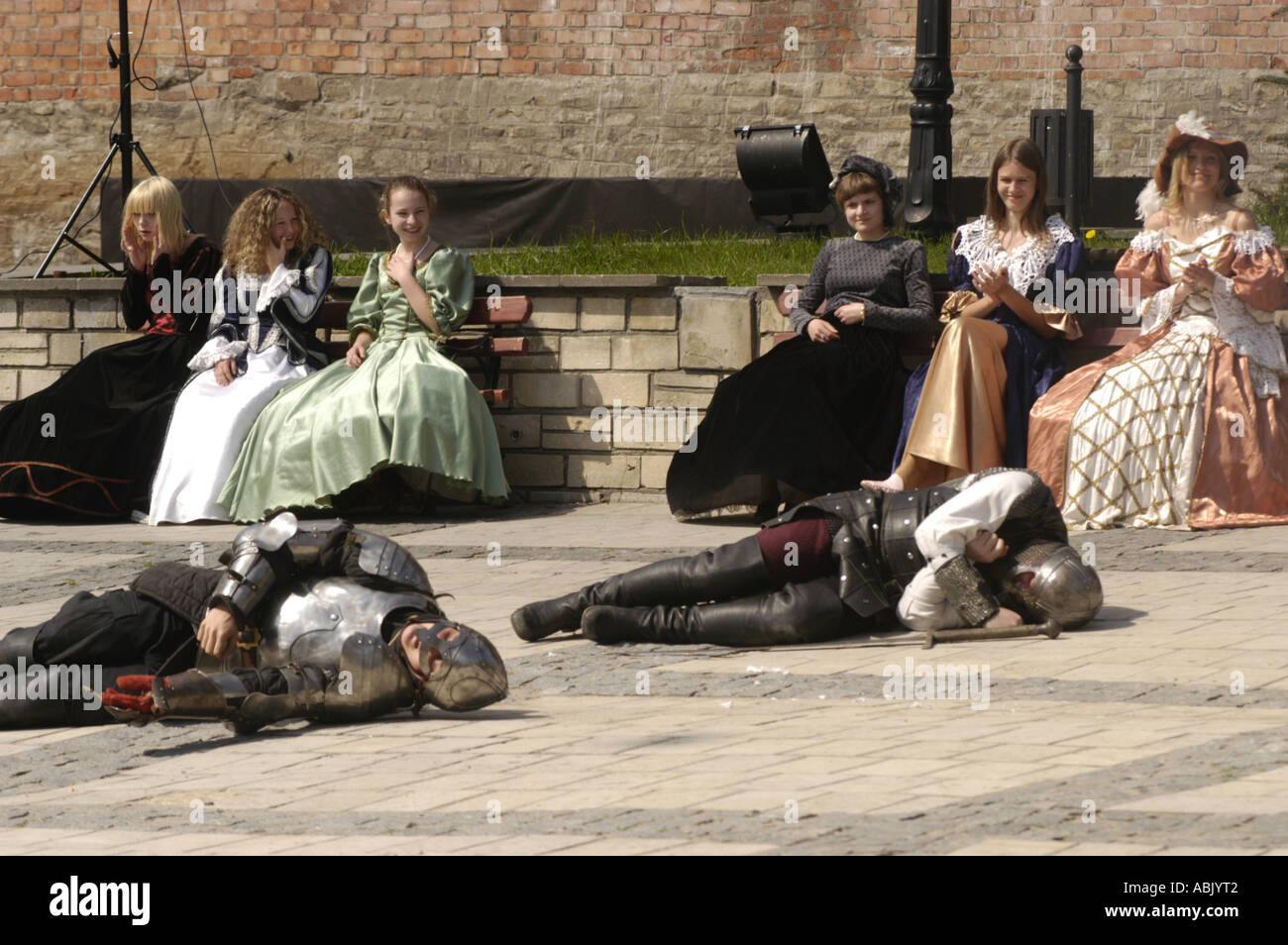 Dead knights in armour and helmet with sword and watching women in ...