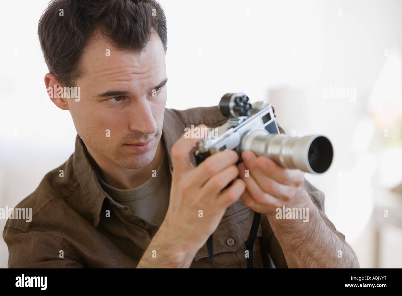 Man looking through camera Stock Photo - Alamy