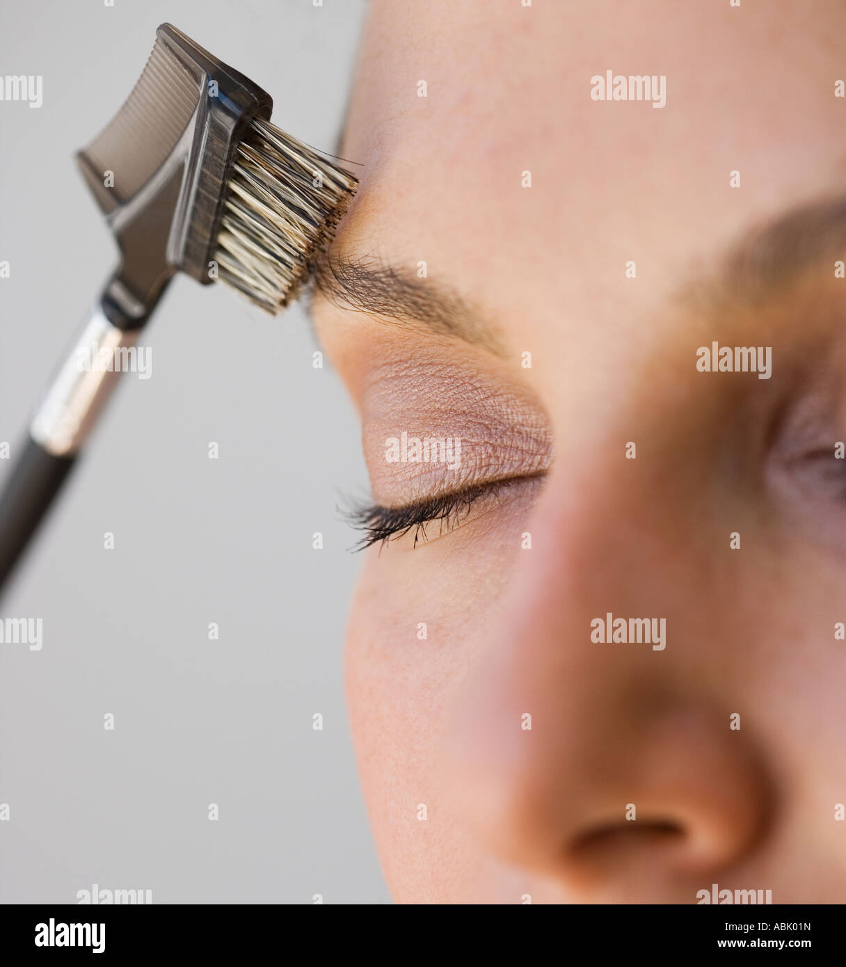 Woman brushing eyebrow Stock Photo - Alamy