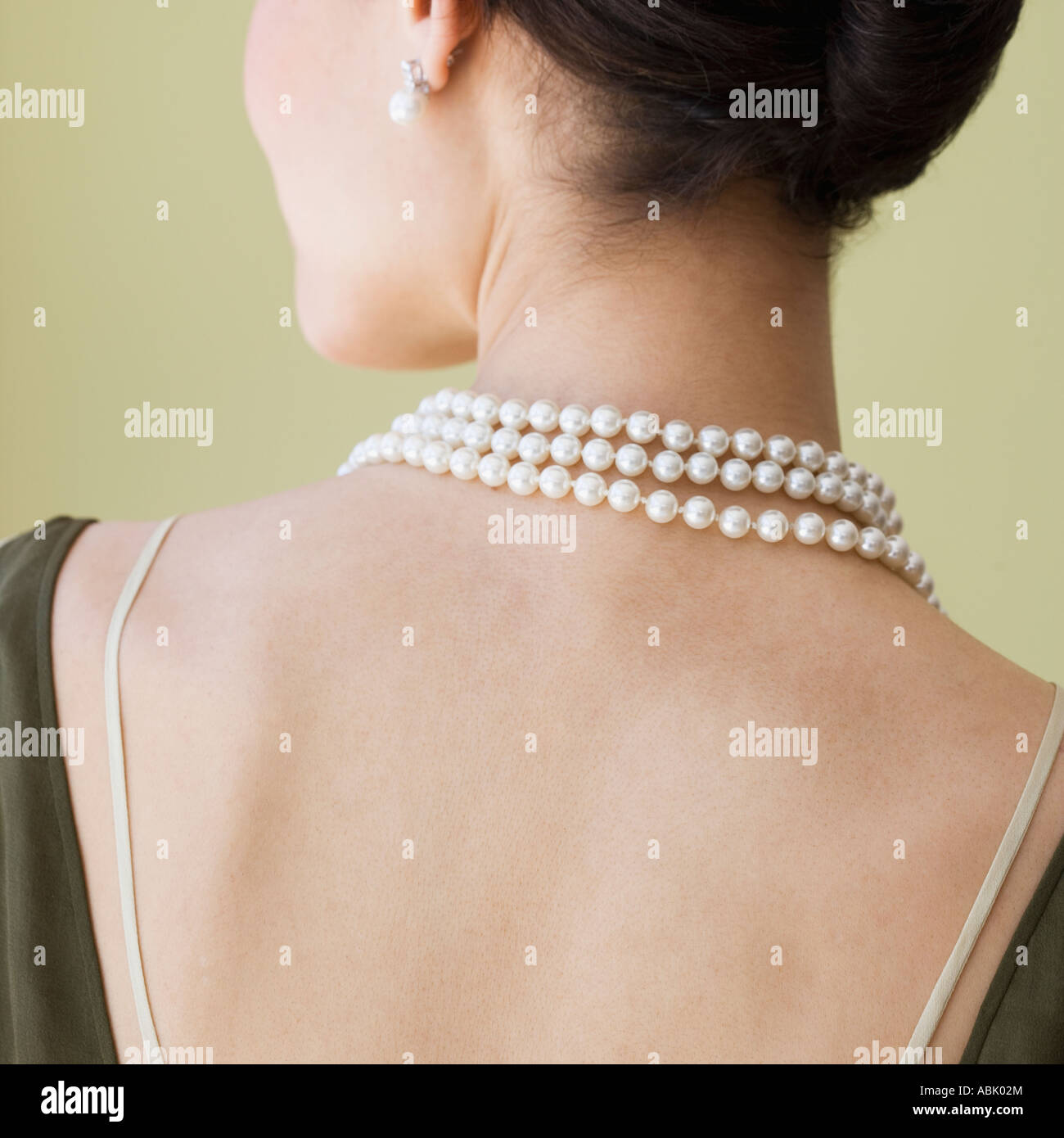 Rear view of woman wearing pearl necklace Stock Photo - Alamy