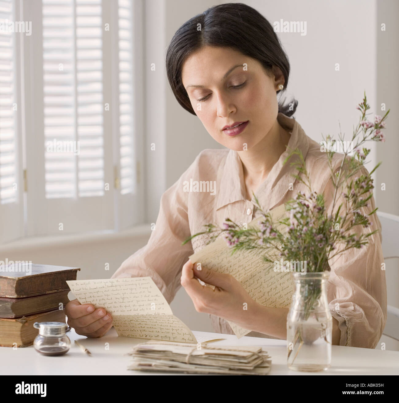Woman in vintage clothing reading letter Stock Photo - Alamy
