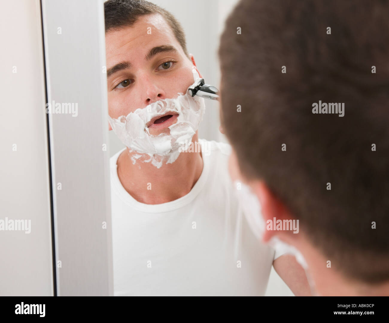 Man shaving in mirror Stock Photo - Alamy