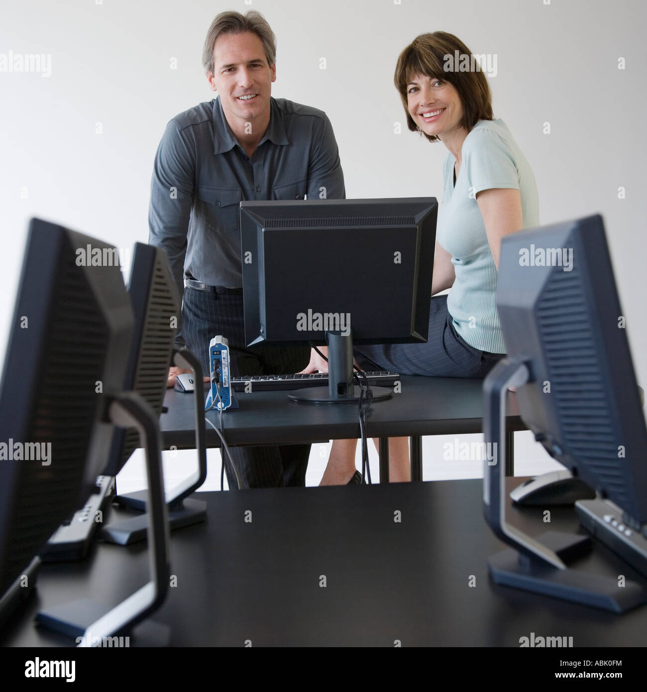 Businesspeople next to computer Stock Photo - Alamy