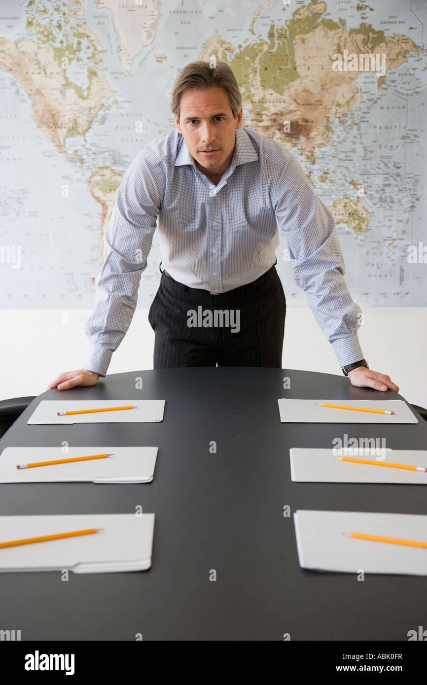 Businessman at head of conference table Stock Photo - Alamy