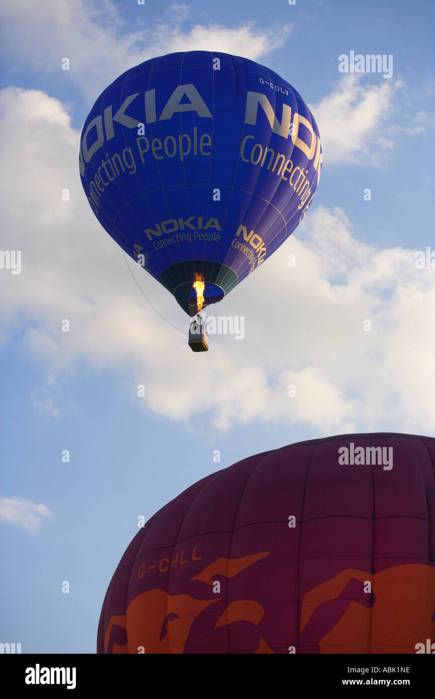 Balloon with Nokia advert and burner alight floats into blue and white ...