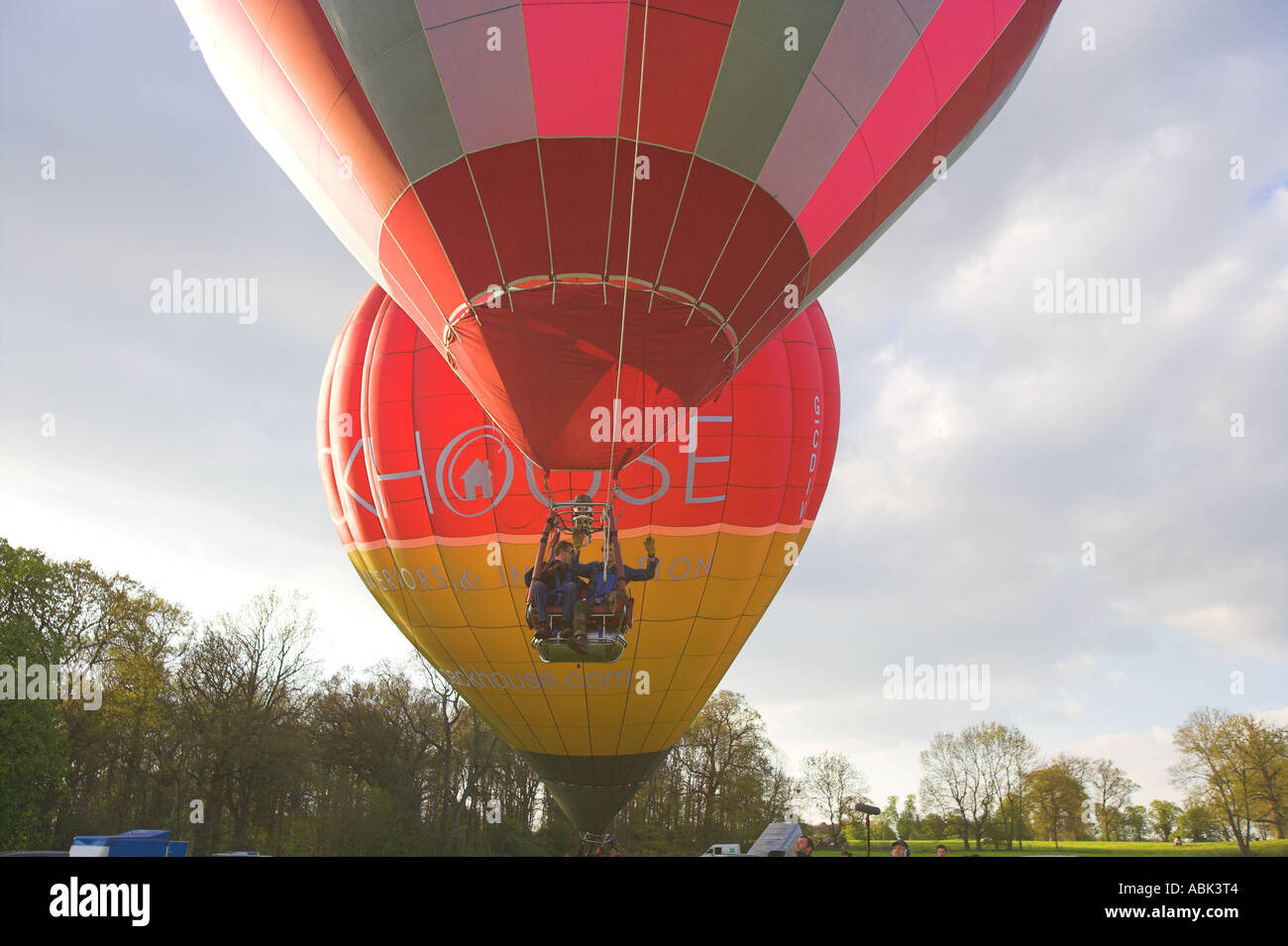 Balloonists wave from rising balloon Stock Photo - Alamy