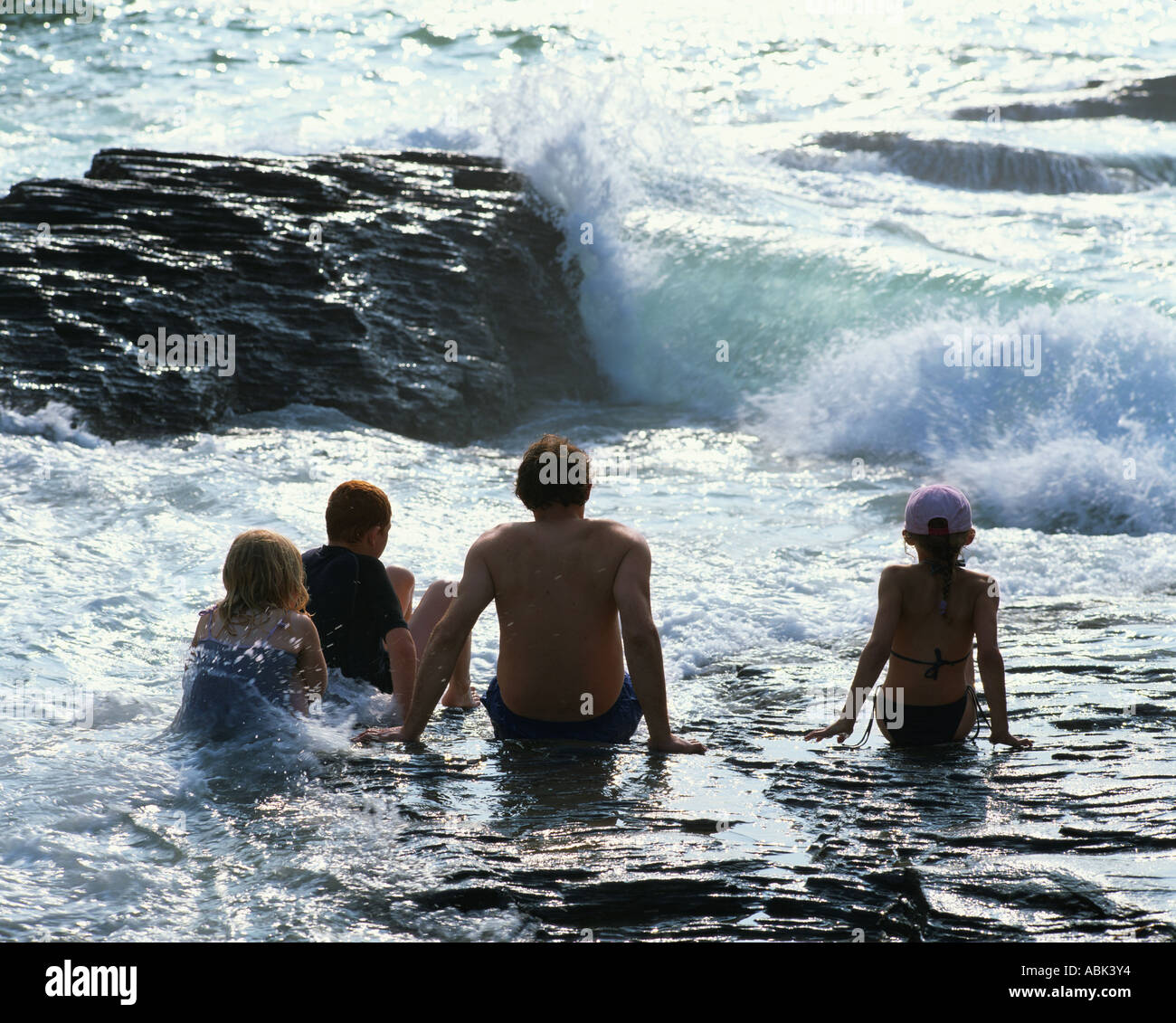 TREBARWITH STRAND PEOPLE WATCHING ROUGH SEA BREAKING ON ROCKS Stock ...
