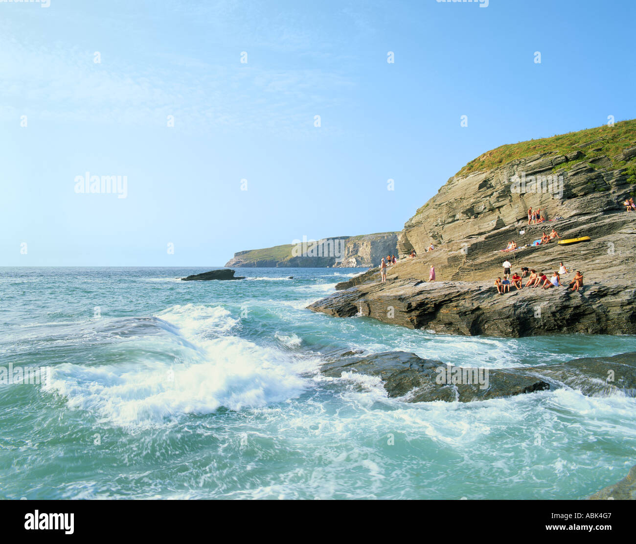 TREBARWITH STRAND PEOPLE WATCHING ROUGH SEA BREAKING ON ROCKS Stock ...